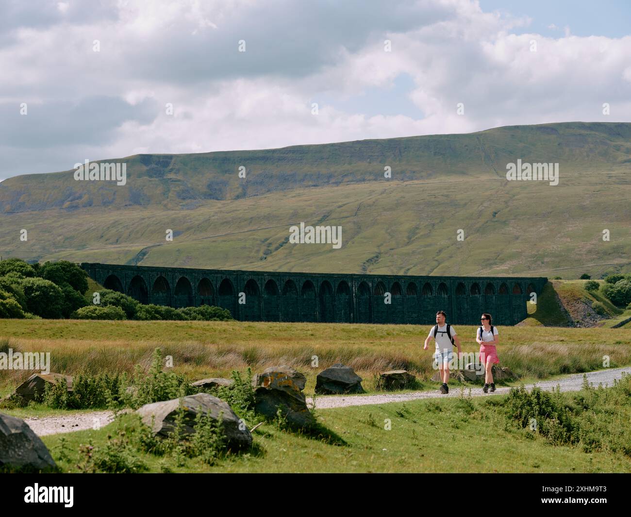 A couple enjoying a walk in the dales at Ribblehead Viaduct on the ...