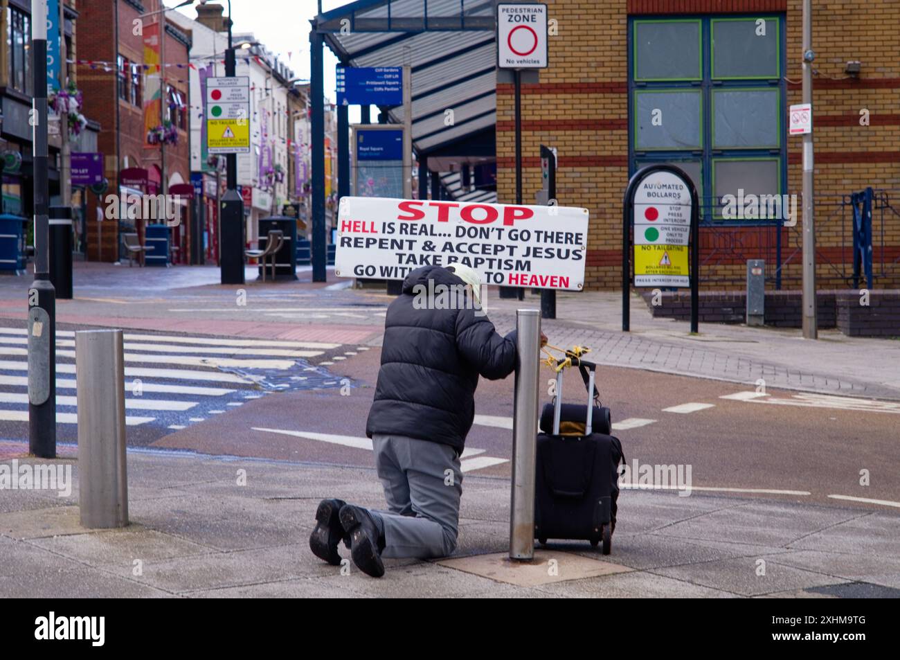 Street preacher praying on his knees at Southend on Sea Stock Photo - Alamy