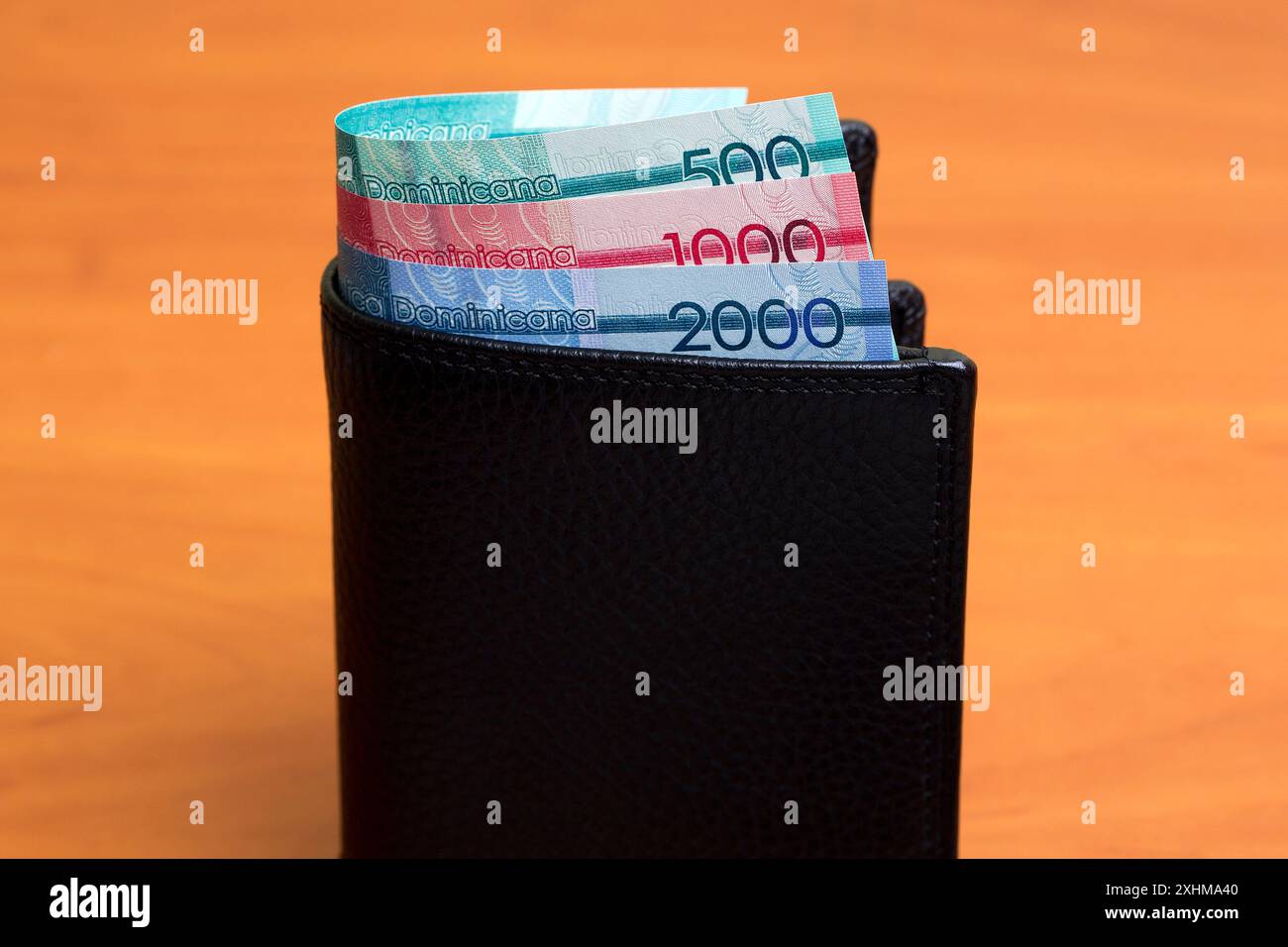 Dominican money - peso in the black wallet Stock Photo - Alamy
