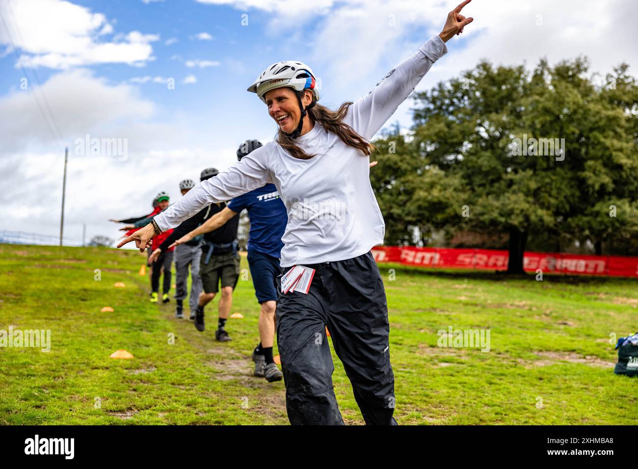 A Group of people enjoying an outdoor activity in a park, wearing ...
