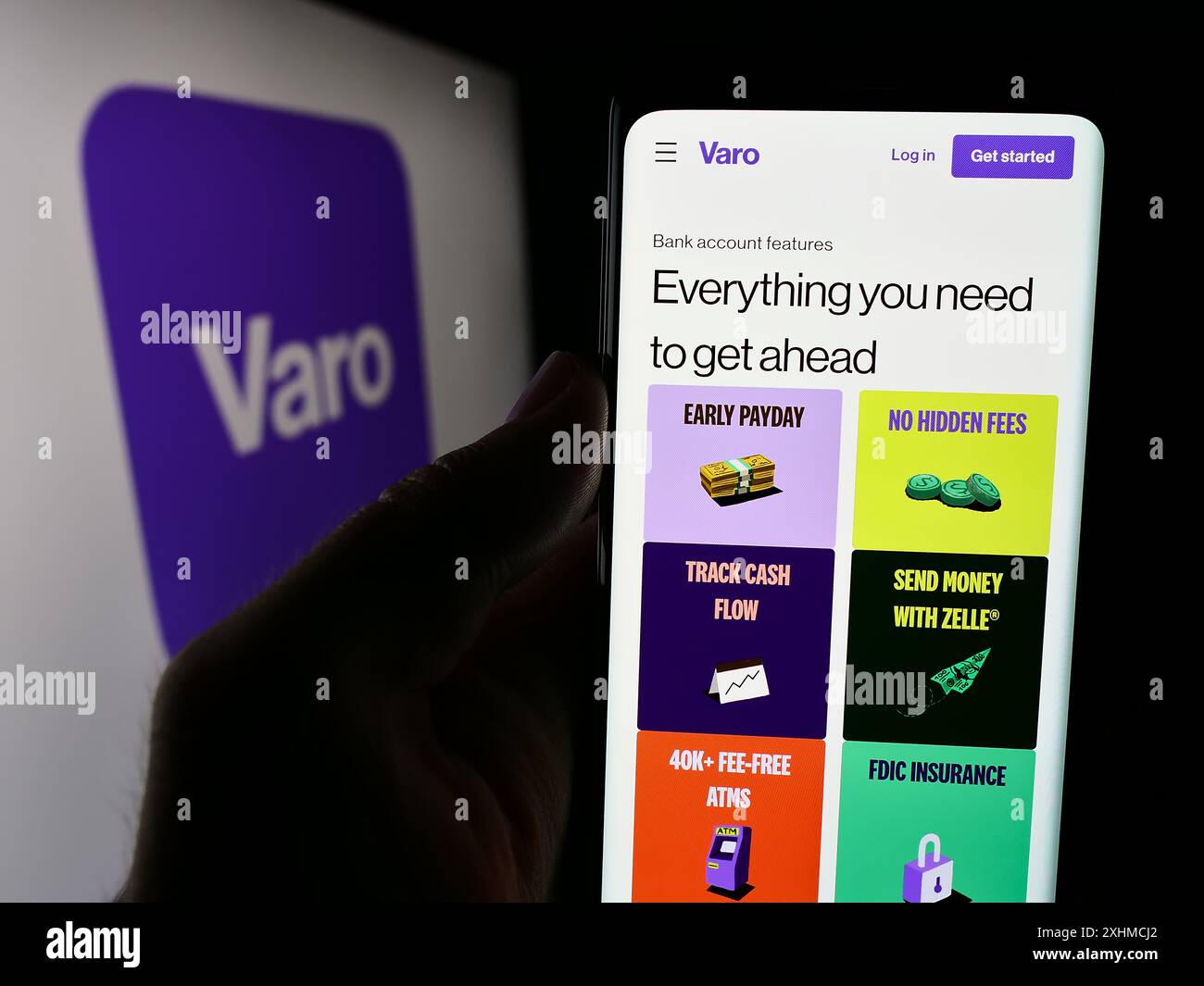 Person holding cellphone with webpage of US financial services company Varo Bank N.A. in front ...