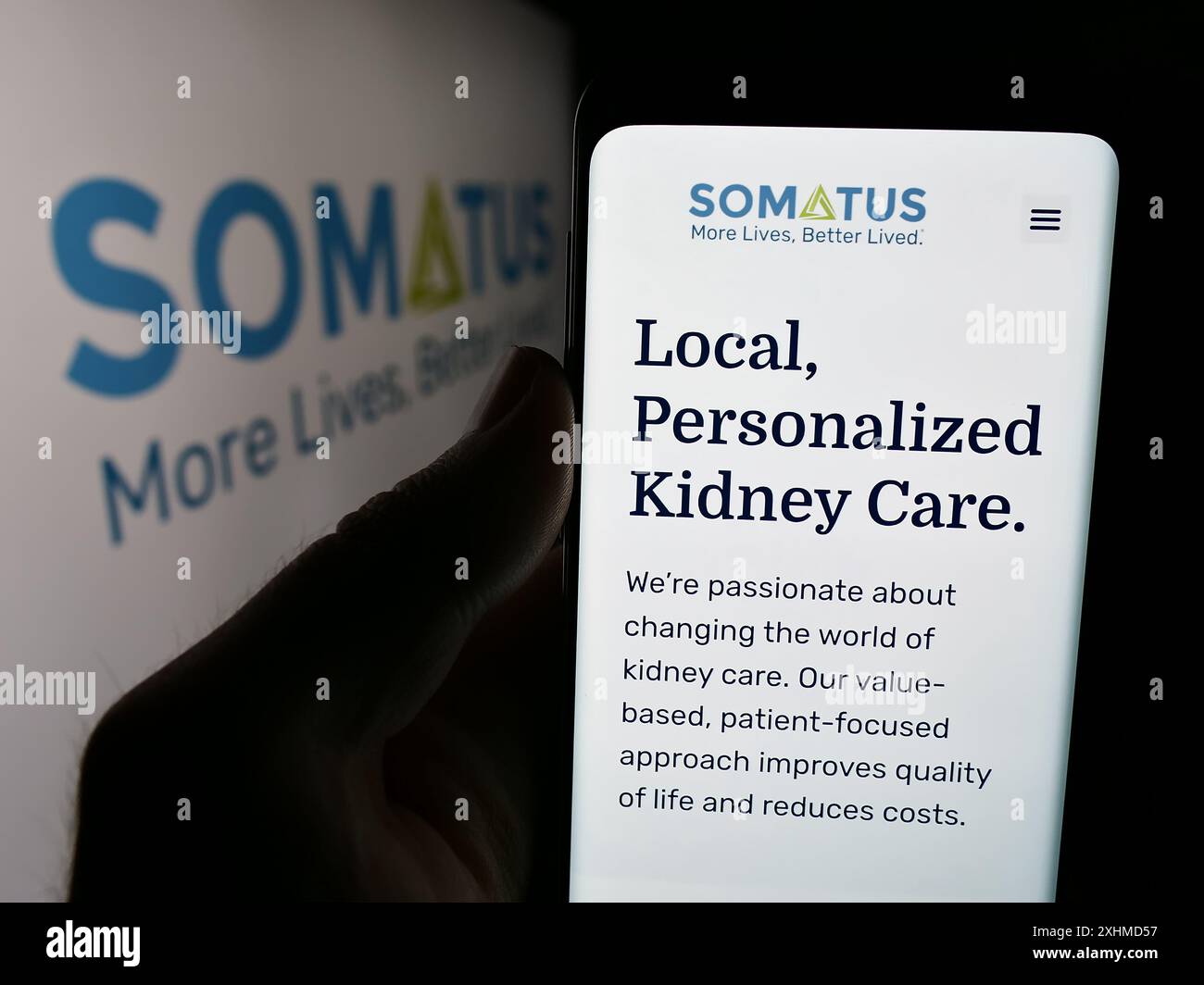 Person holding cellphone with webpage of US kidney care company Somatus Inc. in front of ...