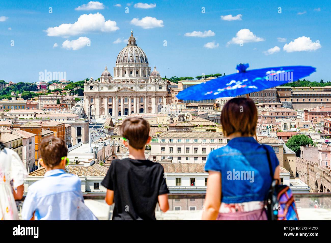 Boys with mother admiring St Peter's Basilica from a terrace, Rome ...