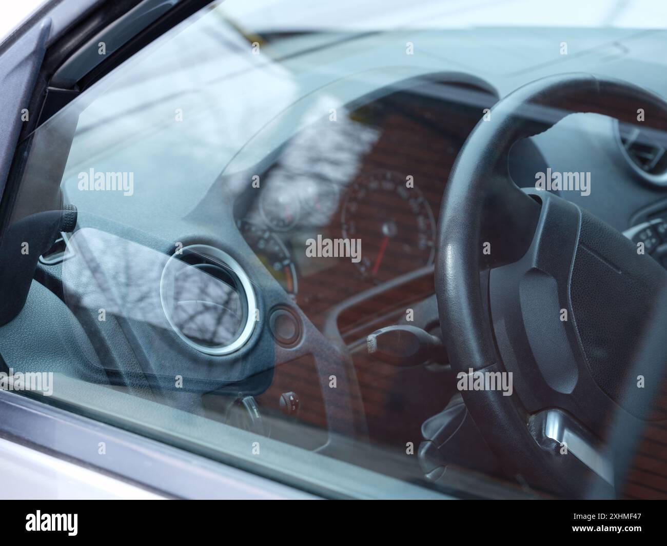 A shot of a car dashboard and steering wheel through a window Stock ...
