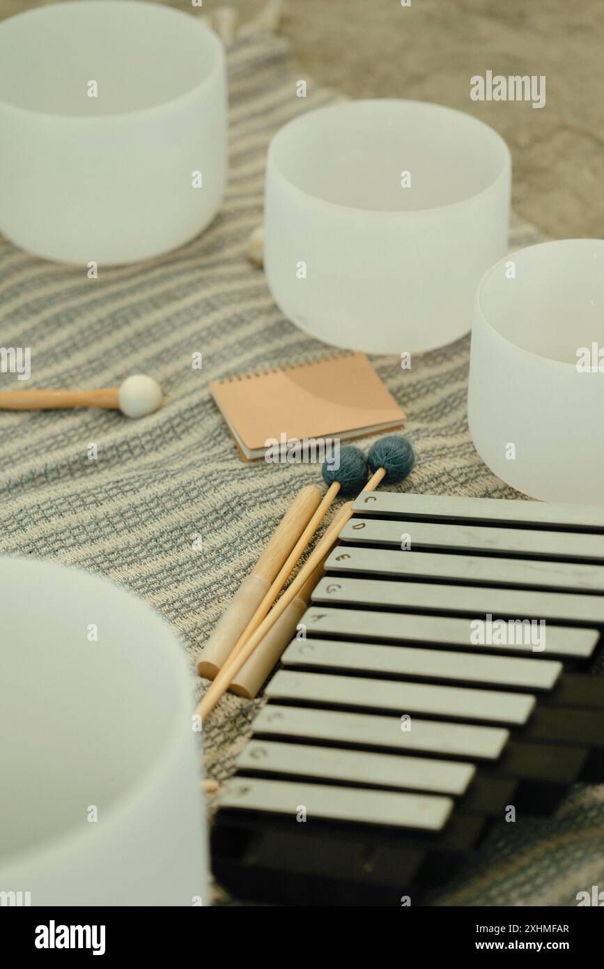 Sound bath instruments arranged on a striped cloth mat Stock Photo - Alamy