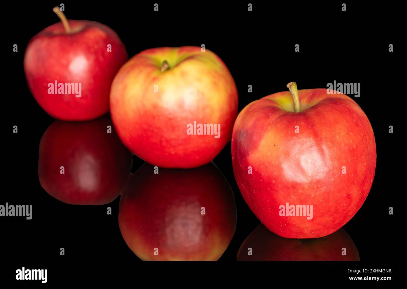 Three sweet red apples, macro, isolated on black background Stock Photo ...