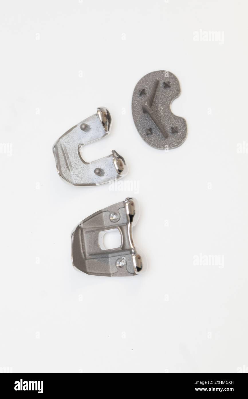 Close-up of various orthopedic knee replacement implants, showcasing ...