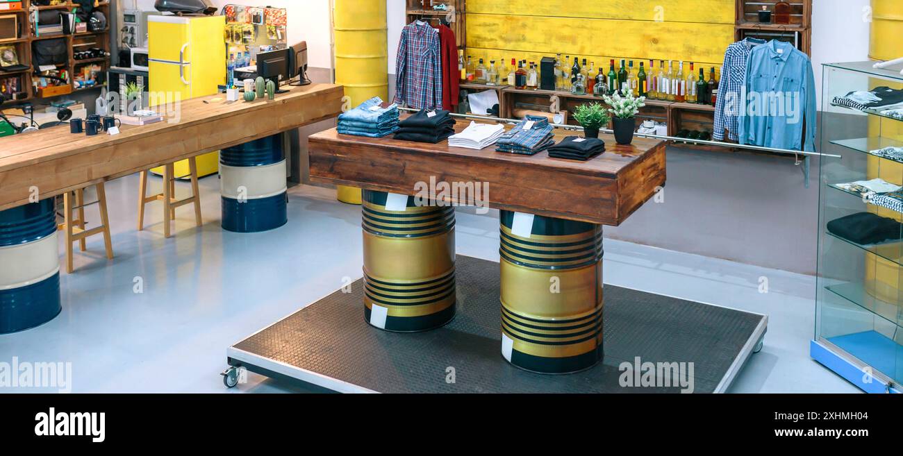 Banner of empty clothing store with clothes on counter over fuel ...
