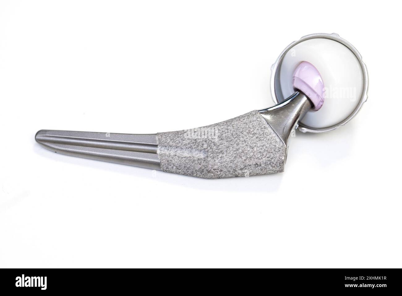 Close-up of a metal hip joint prosthesis on a white background ...
