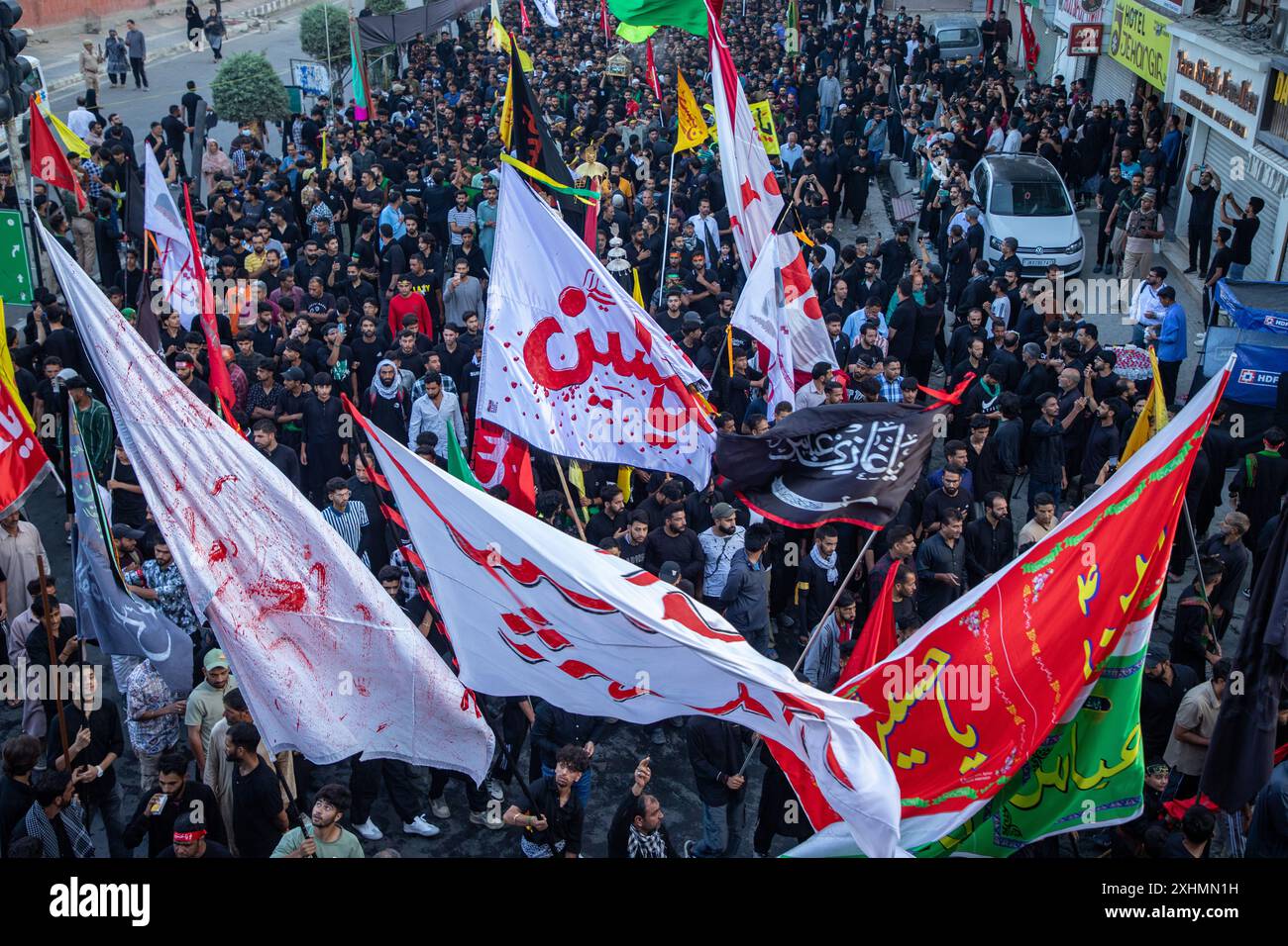 Kashmiri Shiite Muslims hold religious flags as they take part in the ...