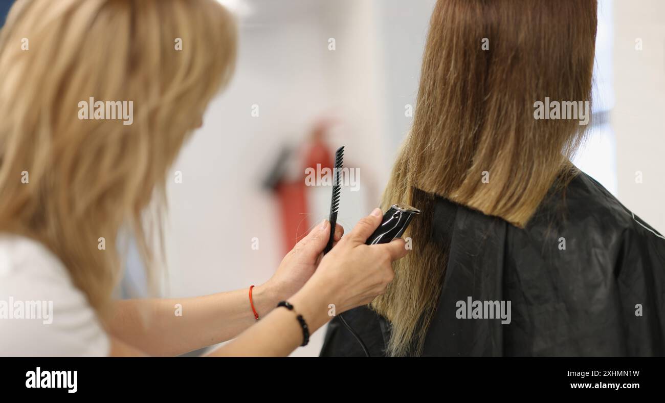 Process of hair cutting at beauty salon, using hair clipper Stock Photo ...