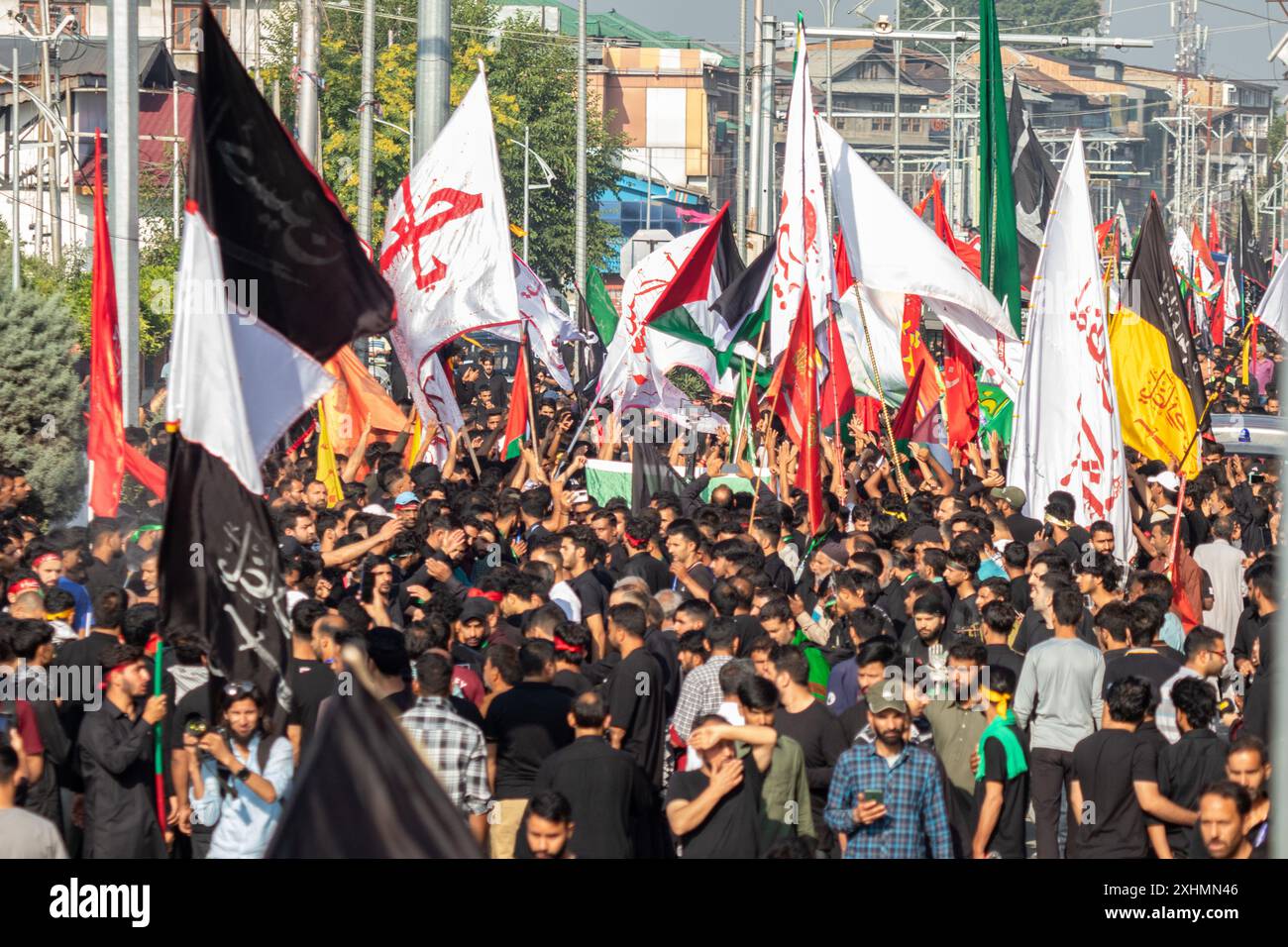 Kashmiri Shiite Muslims hold religious flags as they take part in the ...