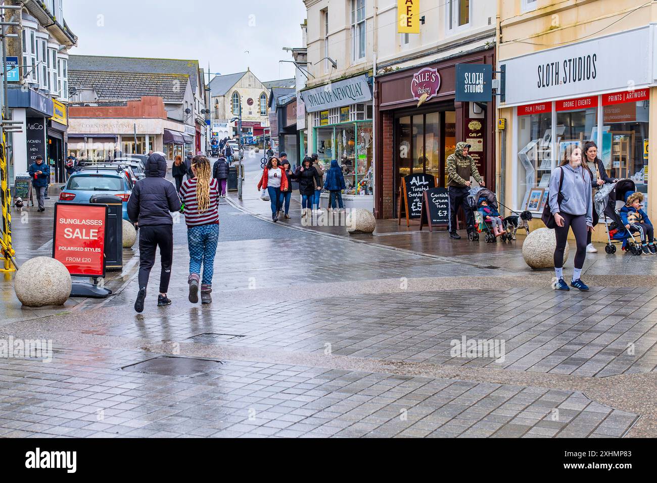 People walking along a street in Newquay town centre in Cornwall in the ...