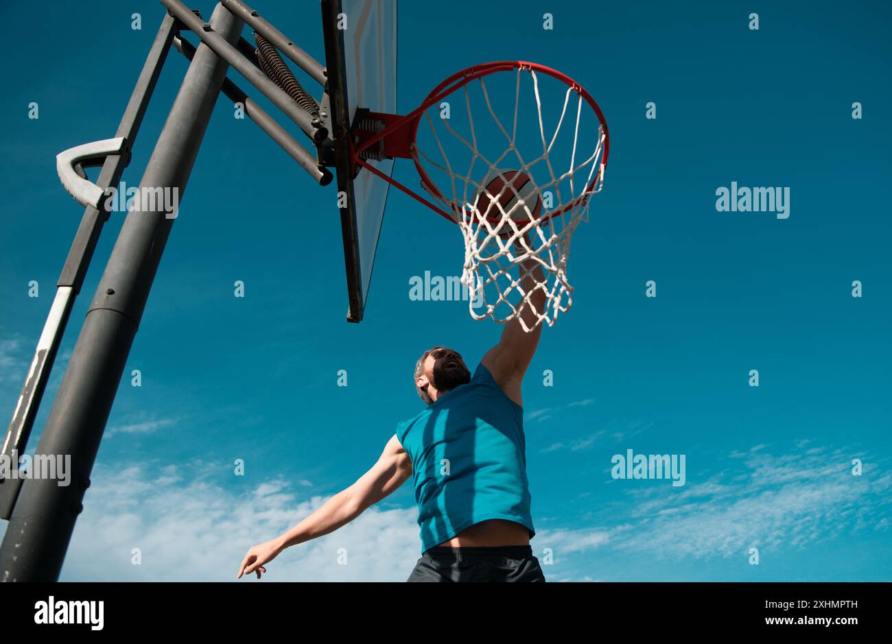 American basketball player scoring a slam dunk Stock Photo - Alamy