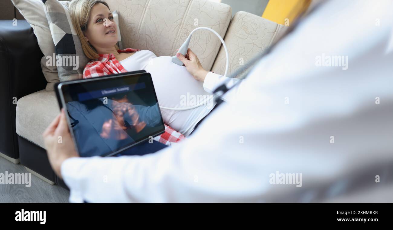 Gynecologist doing ultrasound scan on belly using modern digital ...