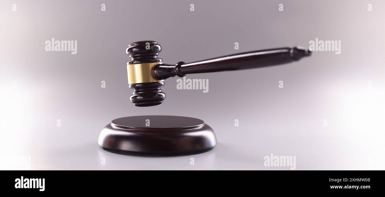 Close-up of wooden judges gavel on soundboard on grey background ...