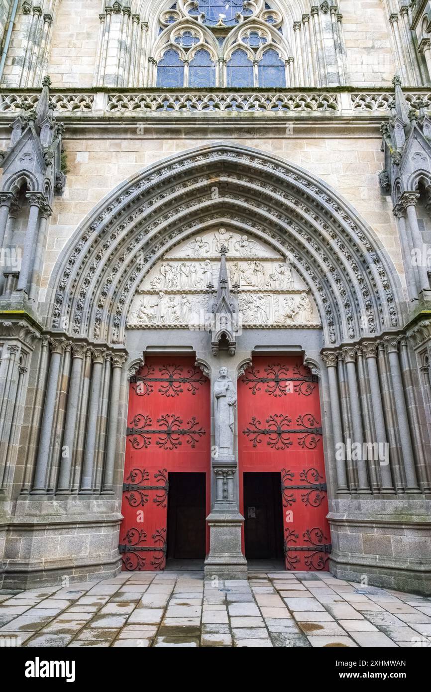 Front entrance of a Gothic cathedral with ornate red doors and detailed ...