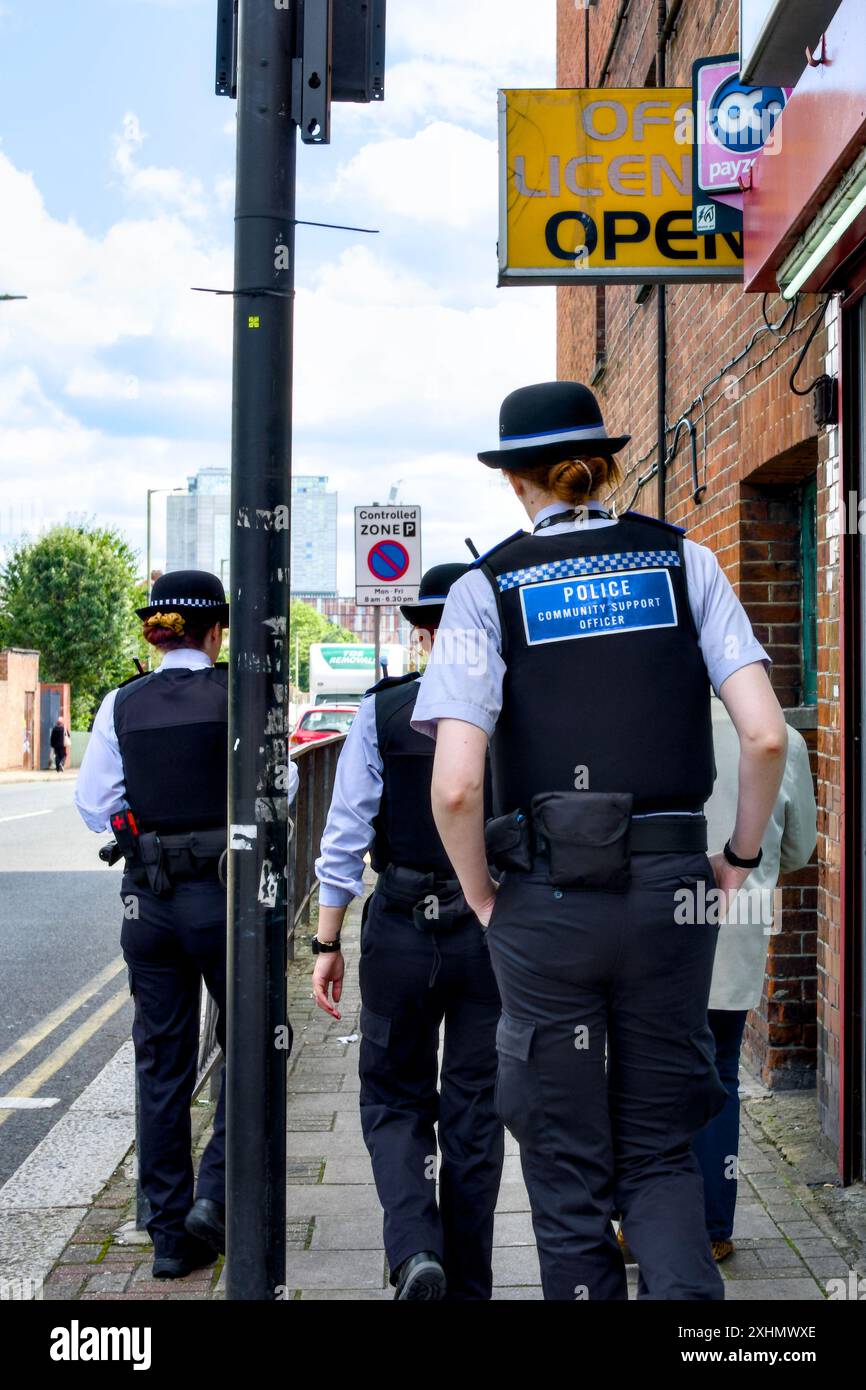 Police Community Support Officers with Police Constable on the Street ...