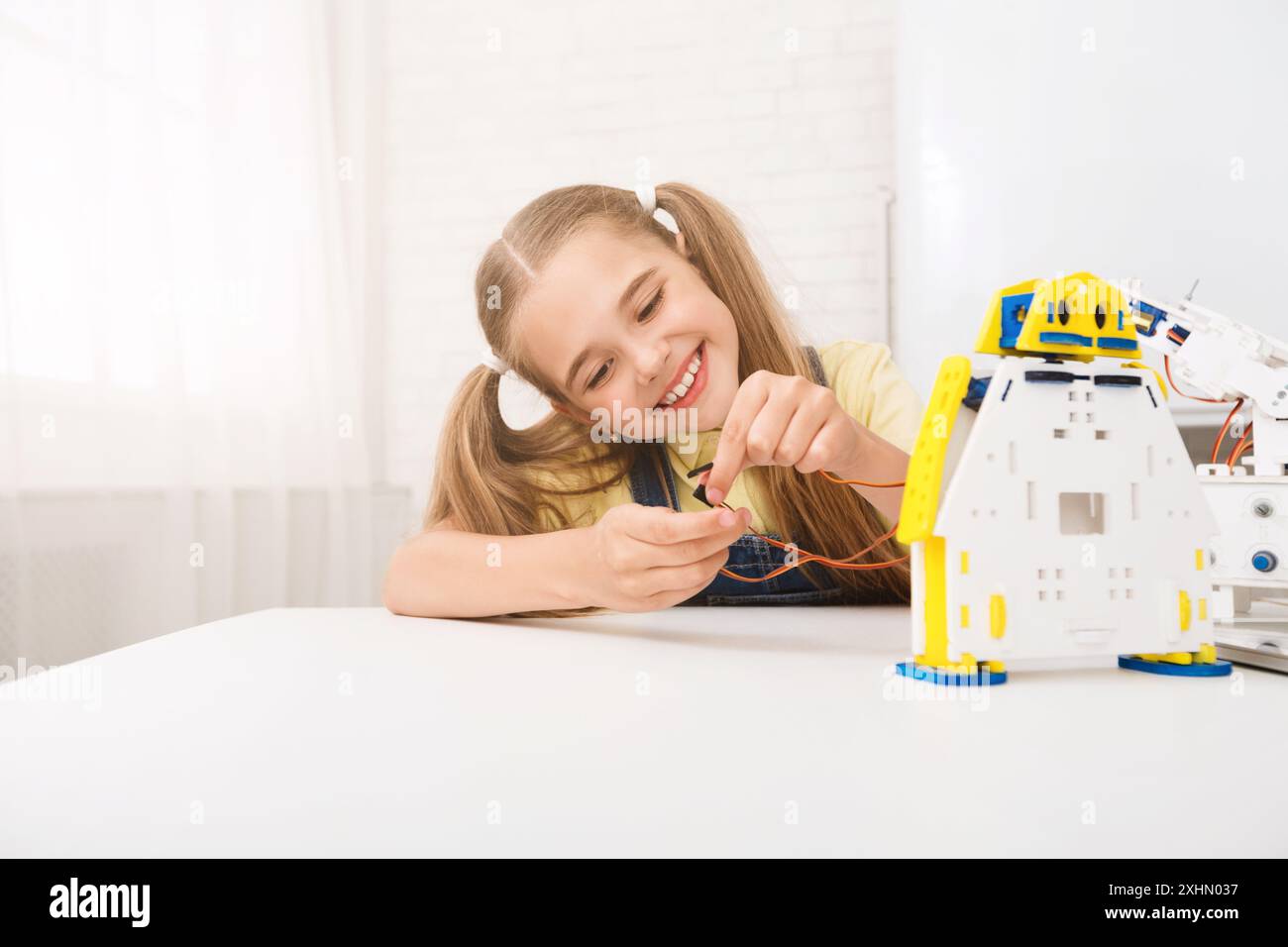 Young Girl Building a Robot With Wires and Parts Stock Photo - Alamy