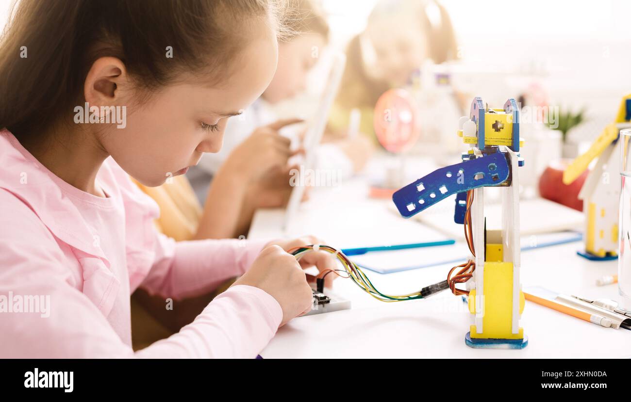 Young Girl Building a Robot in a Classroom Setting Stock Photo - Alamy