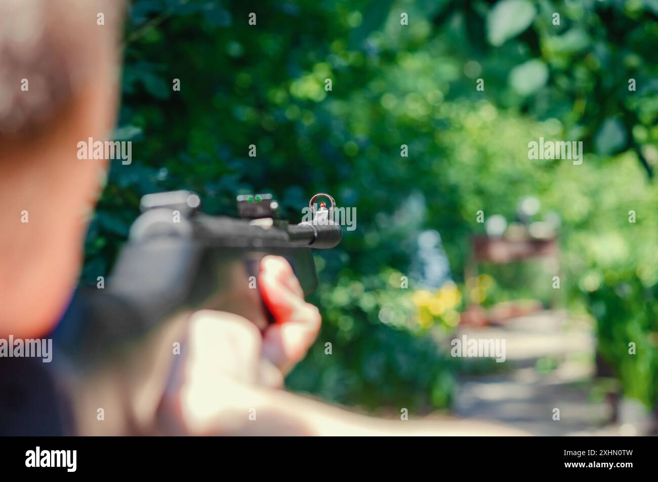 Man is holding gun and aiming. Rifle scope close-up. Selective focus ...