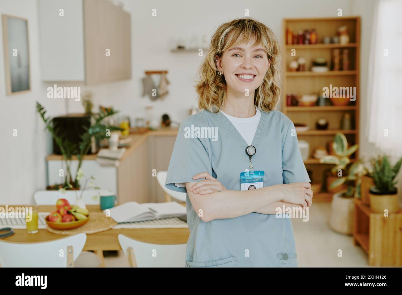 Portrait of happy Caucasian paramedic dressed in light gray scrubs ...
