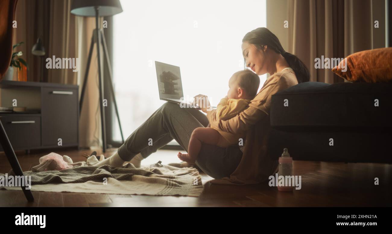 Working from Home: Portrait of Young Asian Mother, Holding her Cute ...