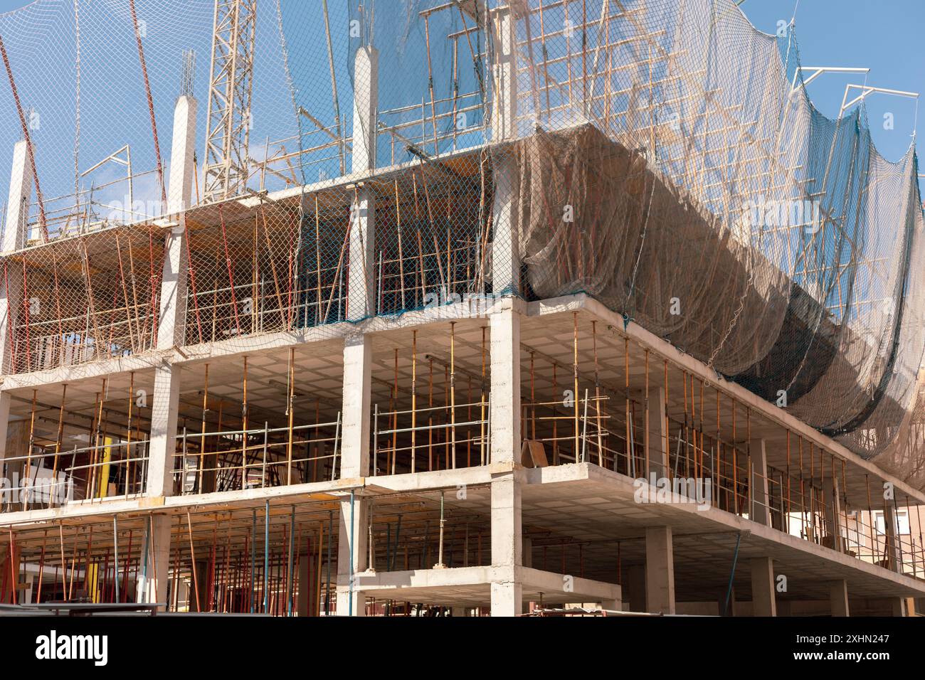 New building construction process. Safety nets and structural beams ...