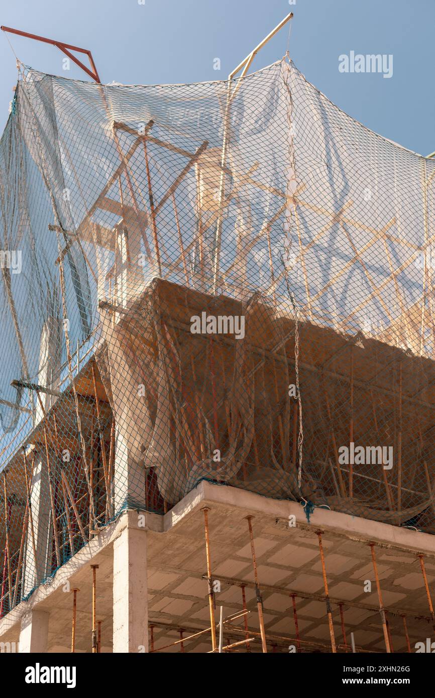 New building construction process. Safety nets and structural beams ...