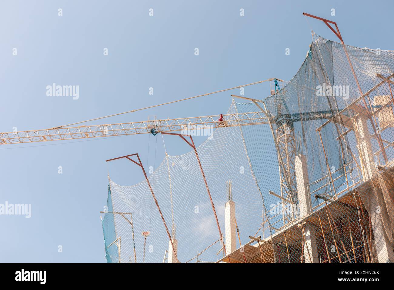 New building construction process. Safety nets, structural beams ...