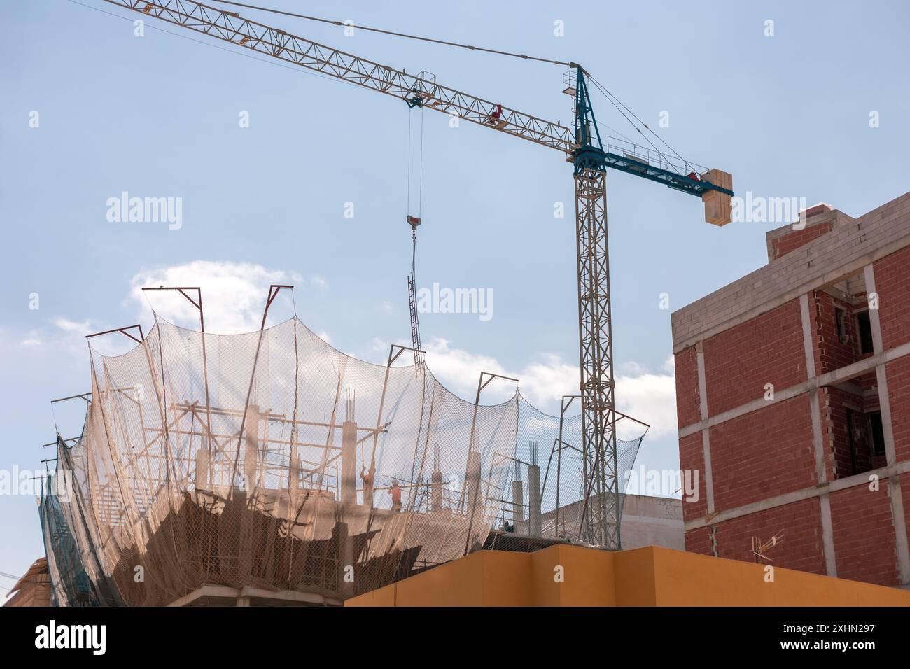 New building construction process. Safety nets and structural beams ...