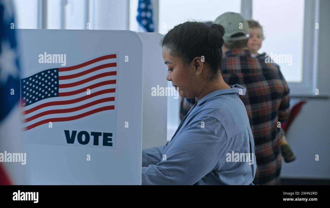 Multi cultural American citizens come to voting booth in polling ...