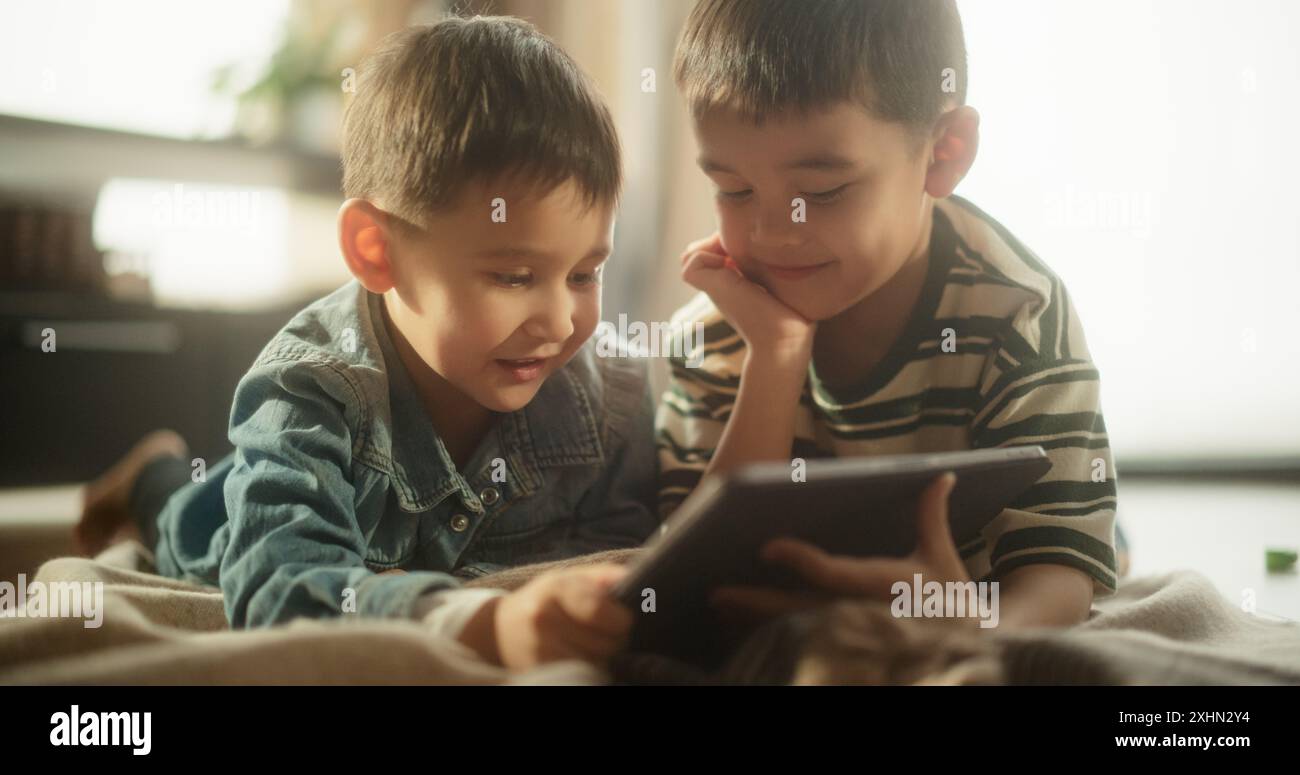 Portrait of Two Male Asian Kids Using a Digital Tablet During Weekend ...