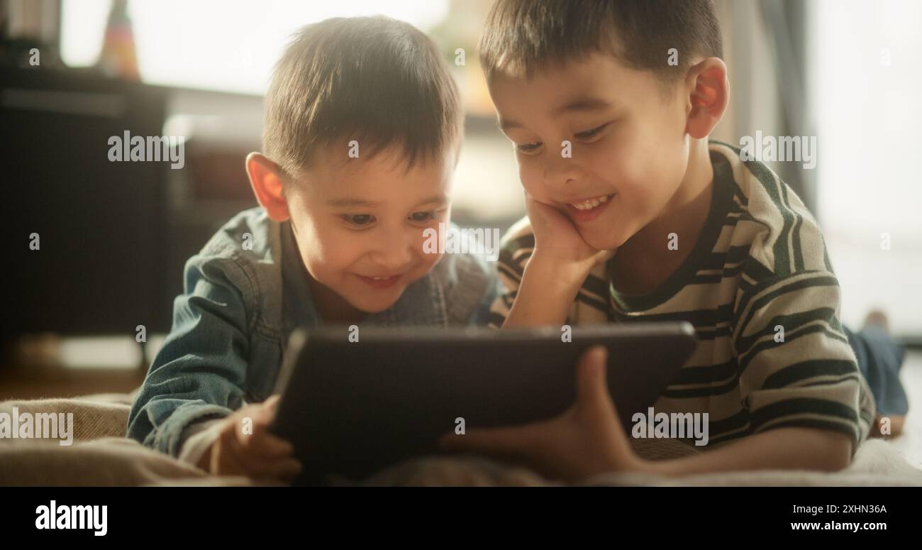 Portrait of Two Male Asian Kids Using a Digital Tablet During Weekend ...