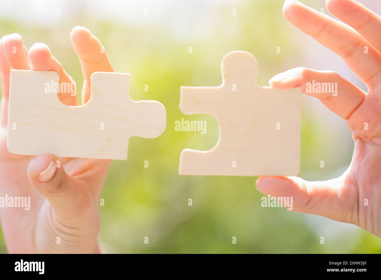 two hands trying to connect couple puzzle piece Stock Photo - Alamy