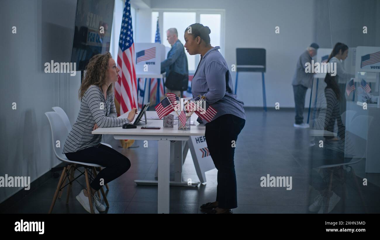 African American woman comes to registration table at polling station ...