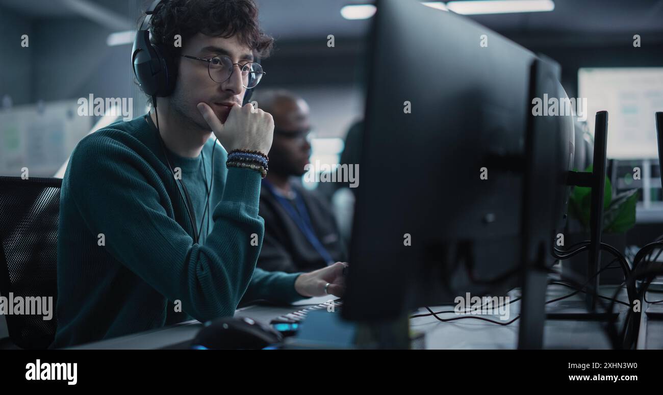 Portrait of a Thoughtful Engineer Working on Desktop Computer in a ...