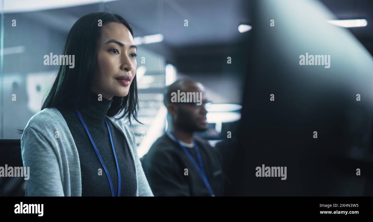 Beautiful Asian Female Working on a Desktop Computer in a Cyber ...