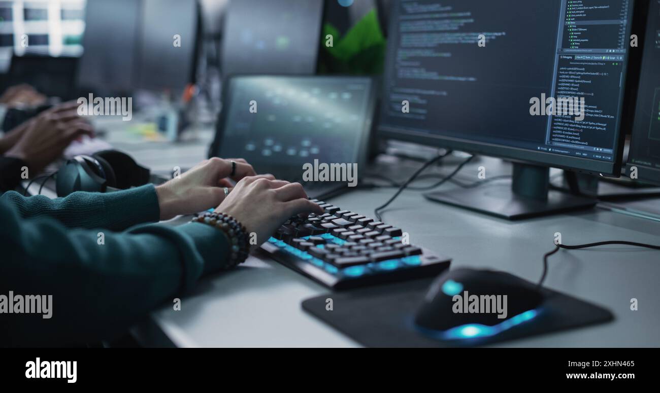 Close Up Of A Software Developer Working On A Desktop Computer Programming Code Running On