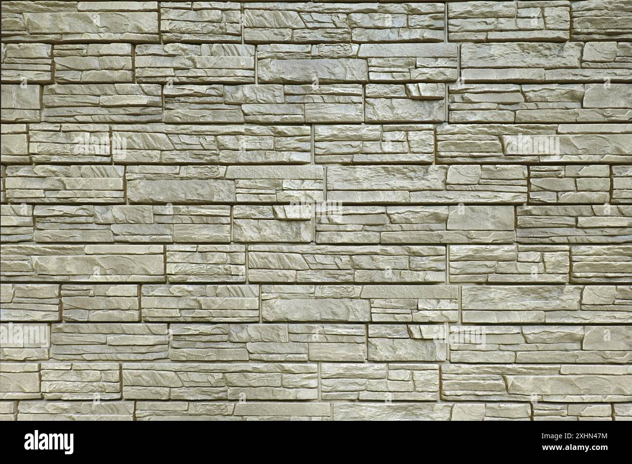 Wall covered from beige decorative brick panels finishing horizontal ...