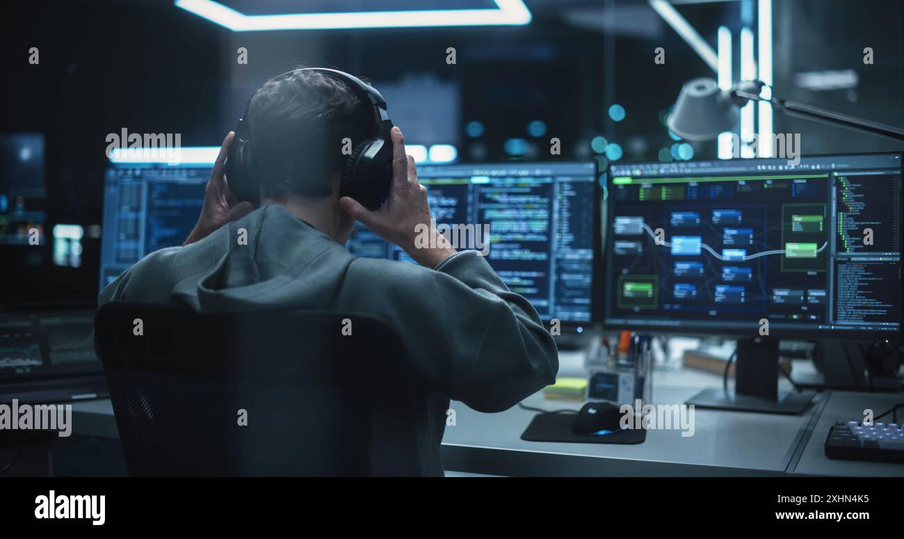 Young hacker programming behind computer hi-res stock photography and ...