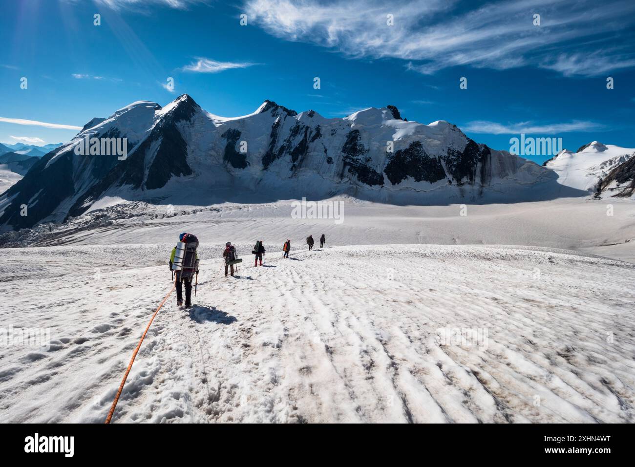 Group mountaineers backpacks roped together hi-res stock photography ...
