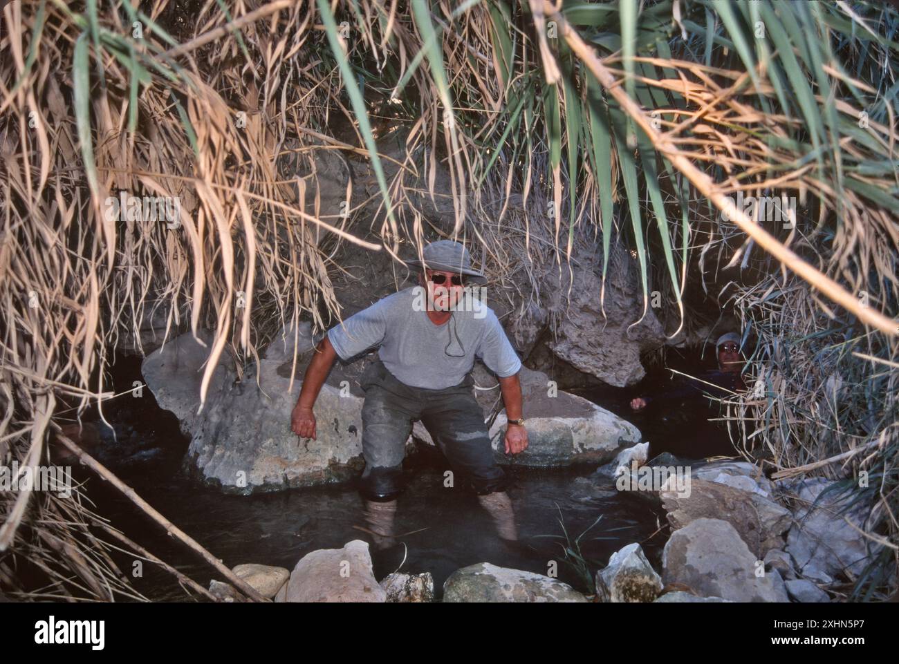 Canoeist relaxing at hot spring in Bullis Canyon, The Lower Canyons, on ...