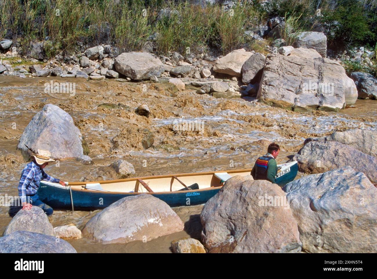 Canoeists lining a canoe to pass Hot Springs Rapids, The Lower Canyons ...
