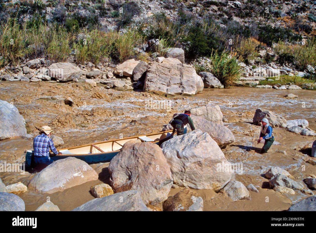 Canoeists lining a canoe to pass Hot Springs Rapids, The Lower Canyons ...