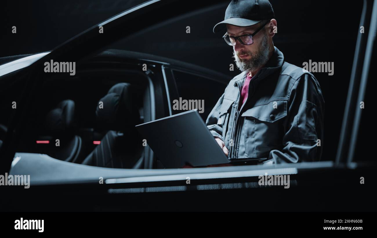 Portrait of a Dealership Car Mechanic Analyzing Diagnostics Results on ...