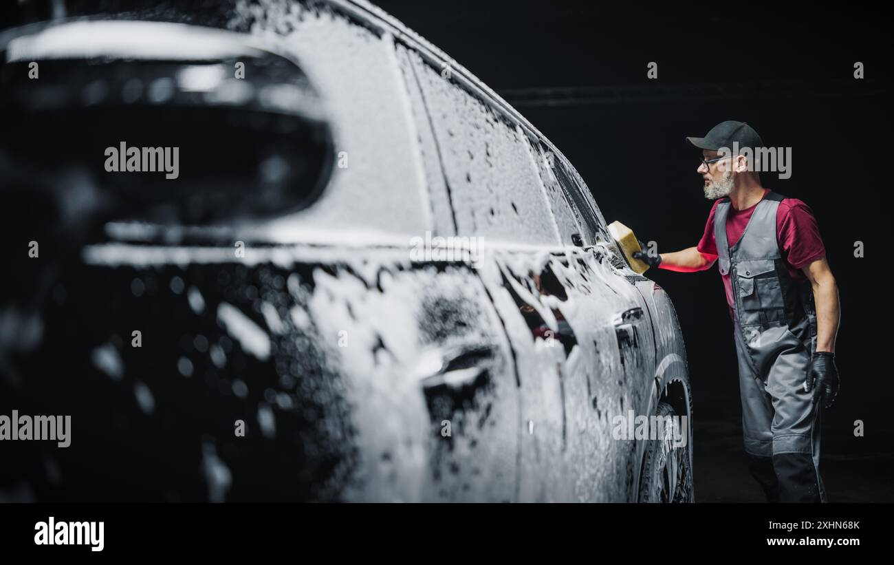 Professional Car Wash Specialist Spreading Foam with a Soft Sponge to ...
