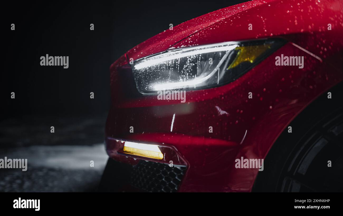 Modern Red Performance Vehicle with LED Headlights is Being Cleaned at ...
