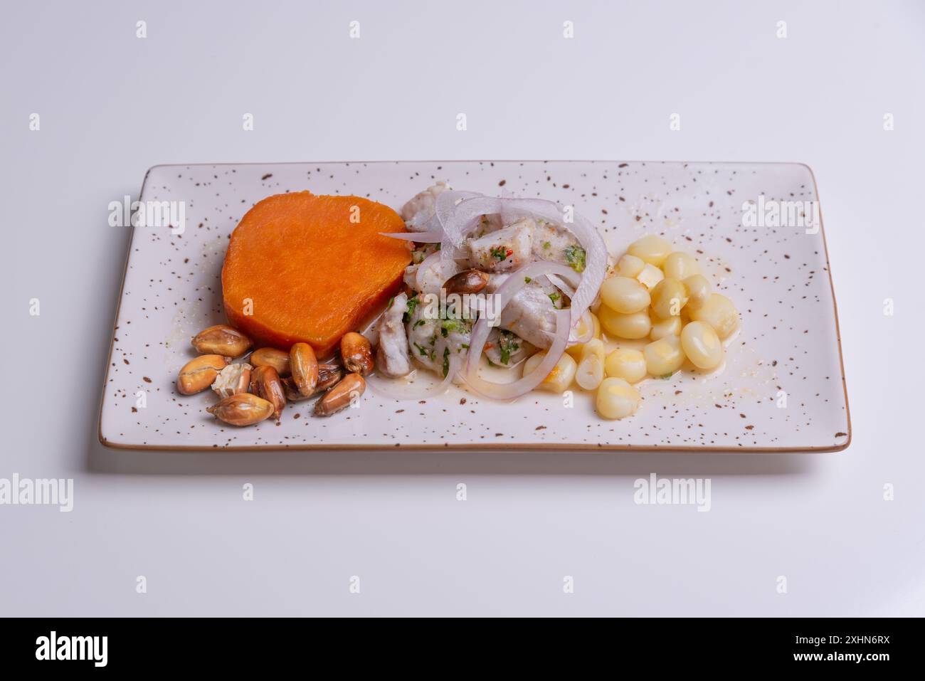 Traditional Peruvian food served on a white tray on a white background ...