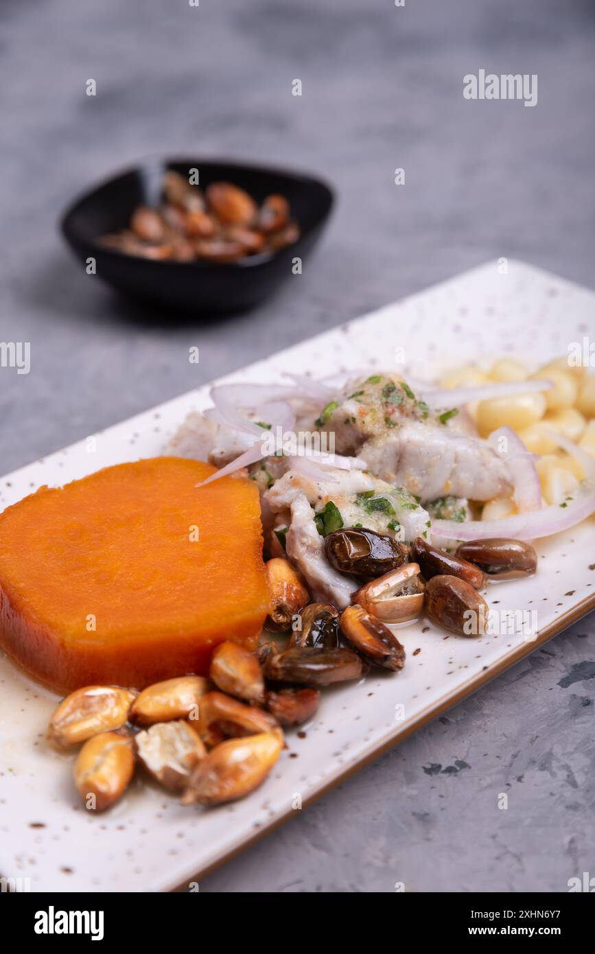 Traditional Peruvian dish called Ceviche with a portion of roasted corn ...